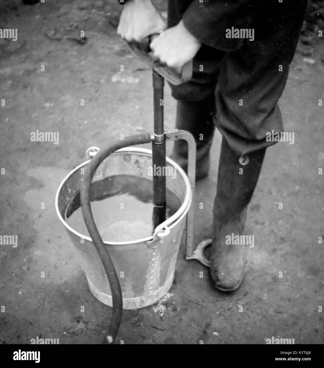 Using a stirrup pump, ARP training exercise during WW2 Stock Photo - Alamy