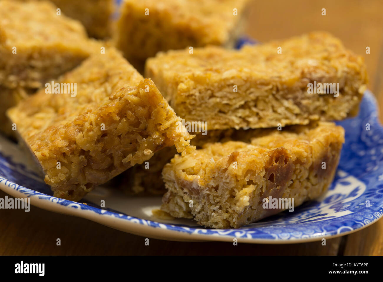 Caramel flapjacks on a dish with wood background Stock Photo - Alamy