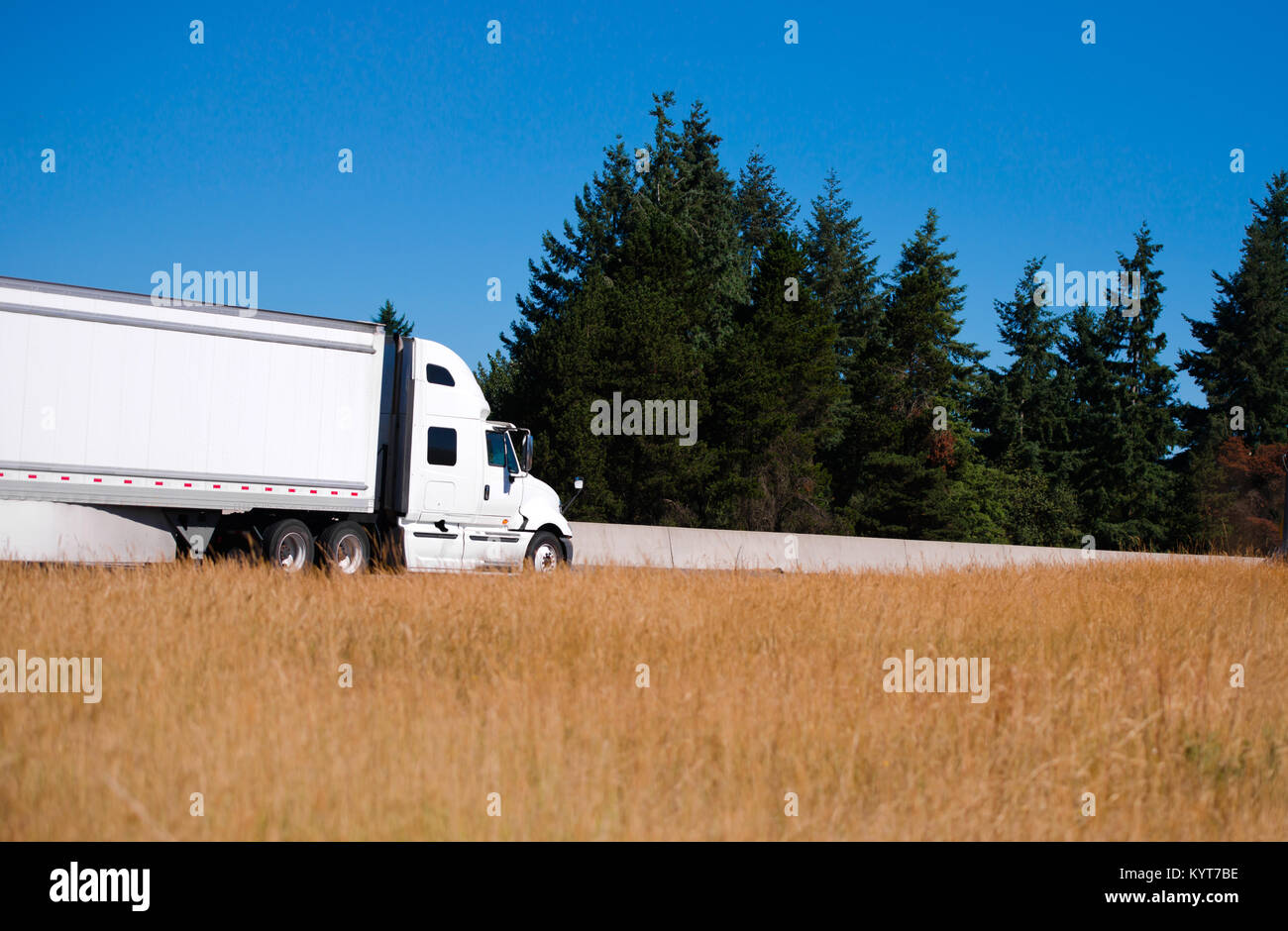 A road train from a clean white big rig modern semi truck and semi ...