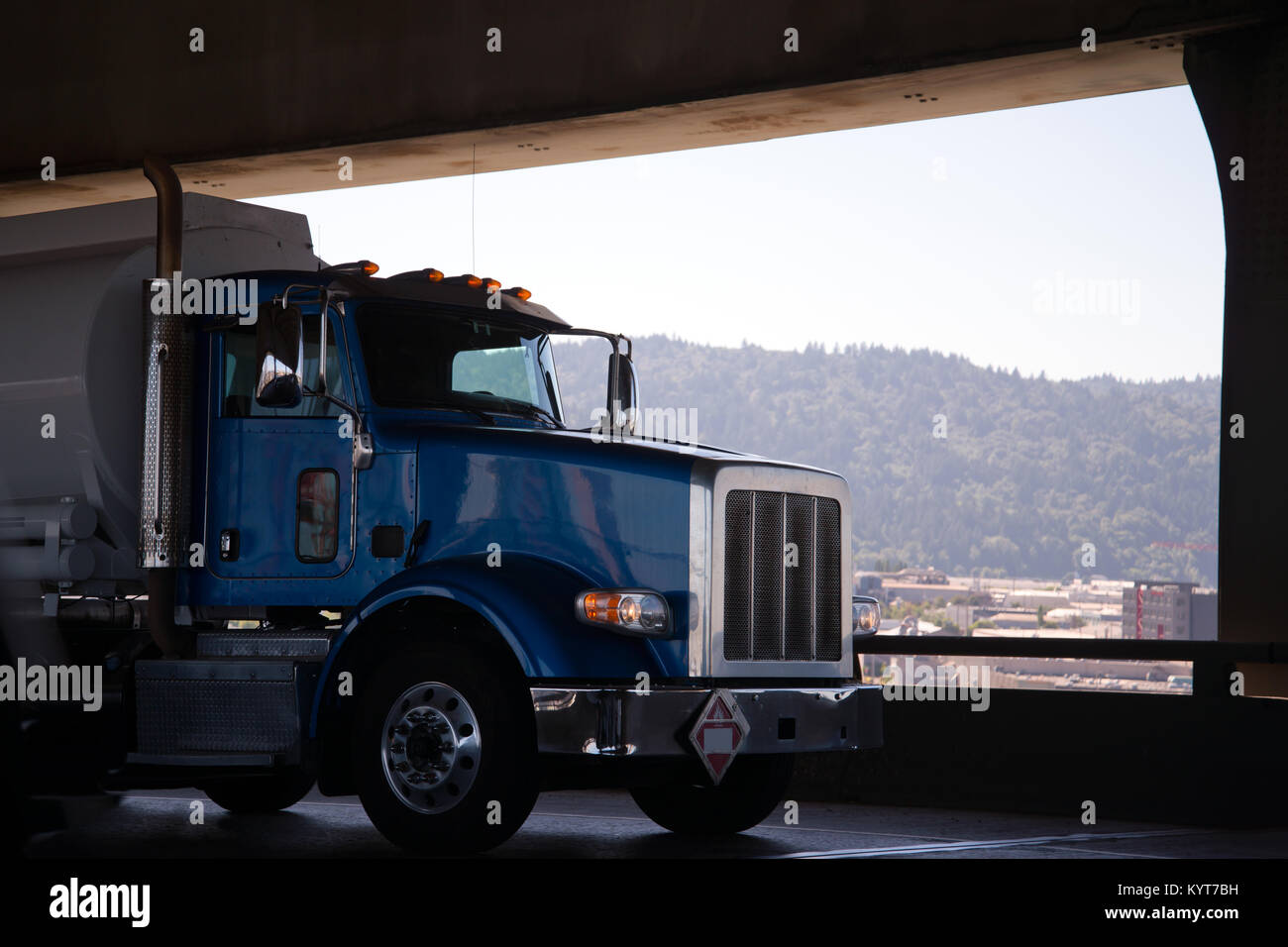 A modern simple powerful bright blue big rig semi truck with day cab ...