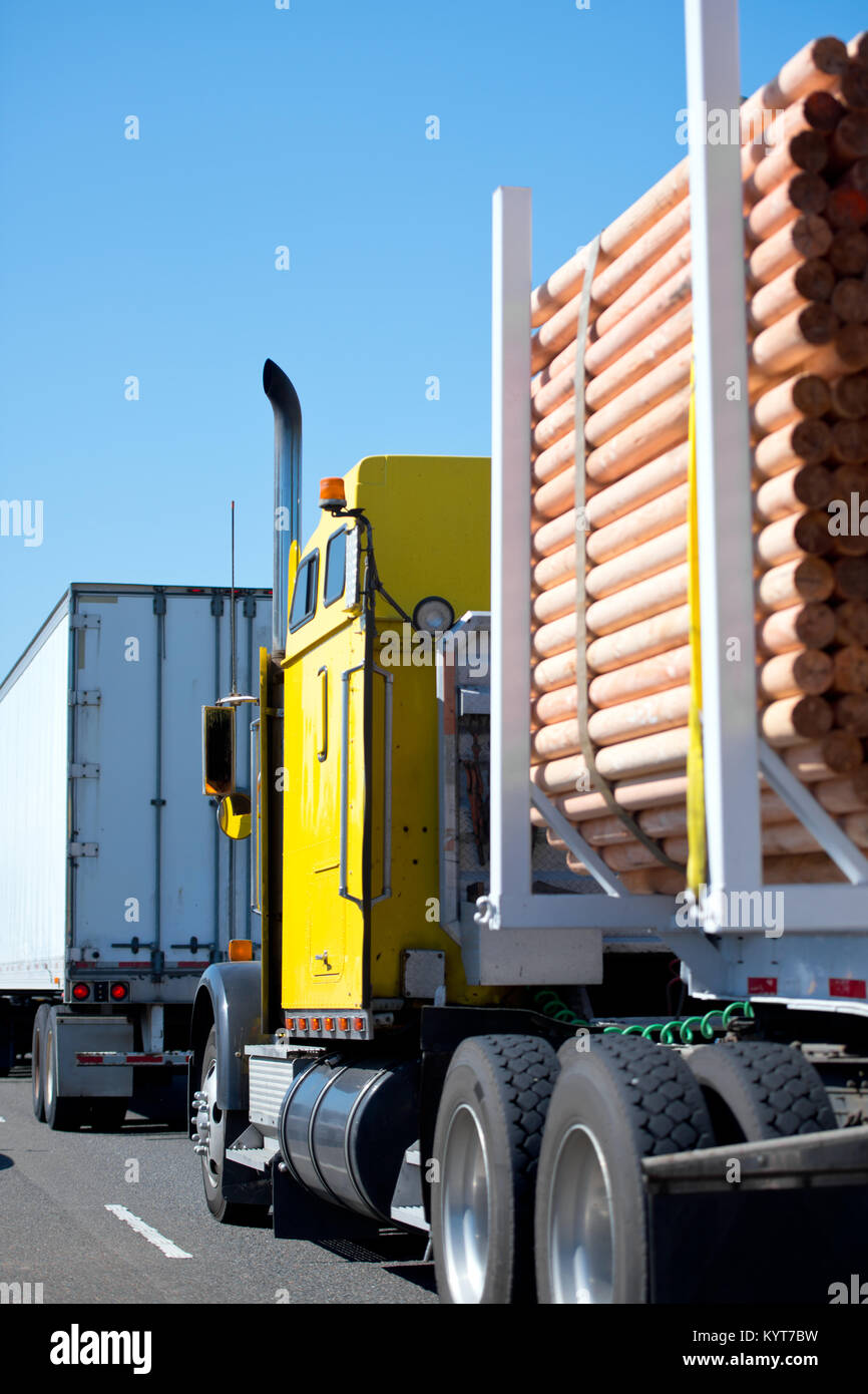 A classic simple powerful bright yellow big rig semi truck with long ...