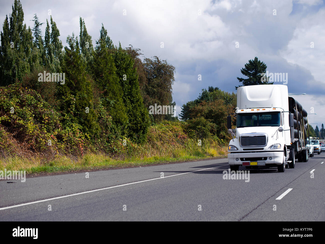 White Bonnet Big rig day cab semi truck with spoiler on the roof moving ...