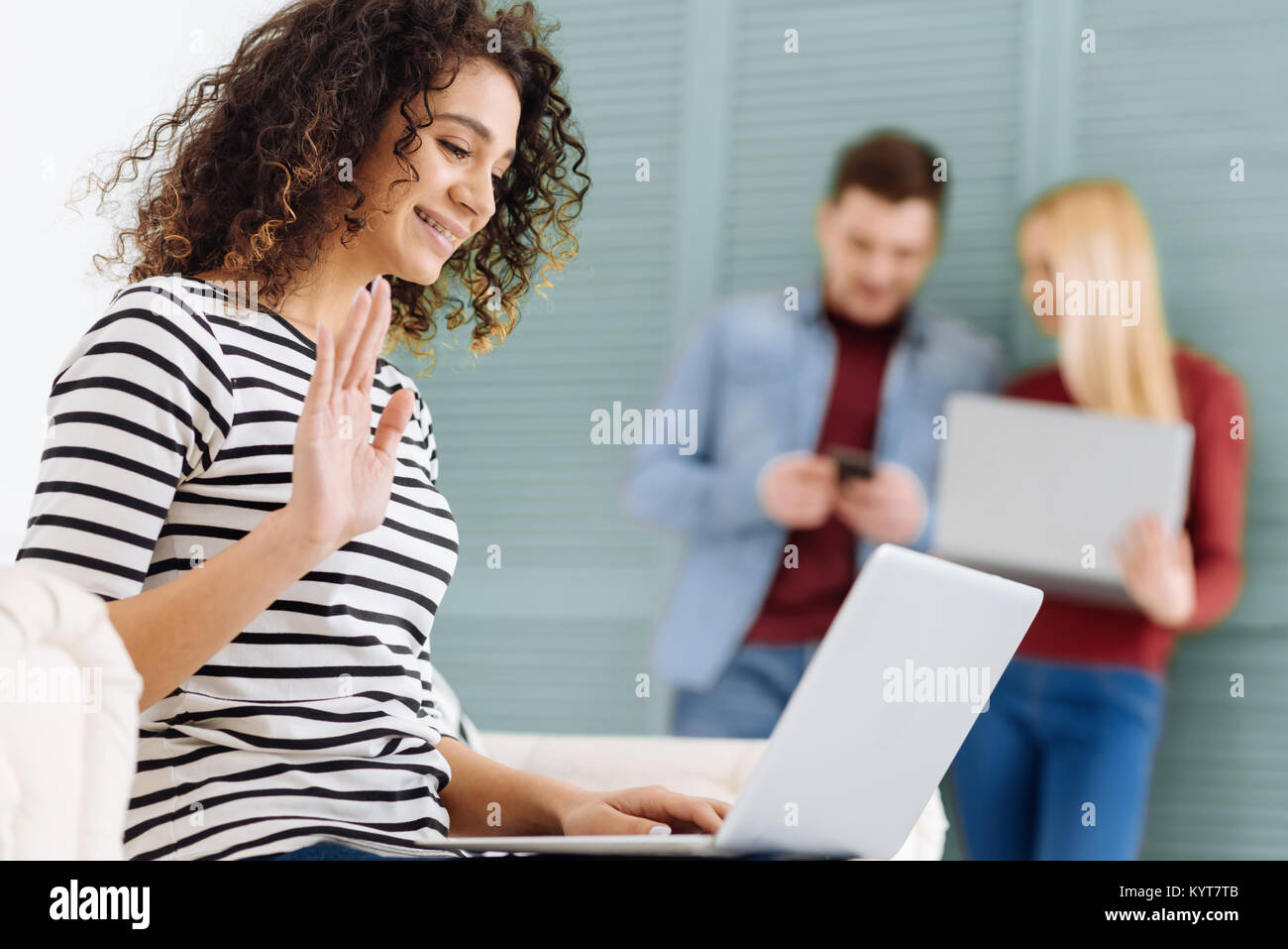 Cheerful female person waving her hand Stock Photo - Alamy