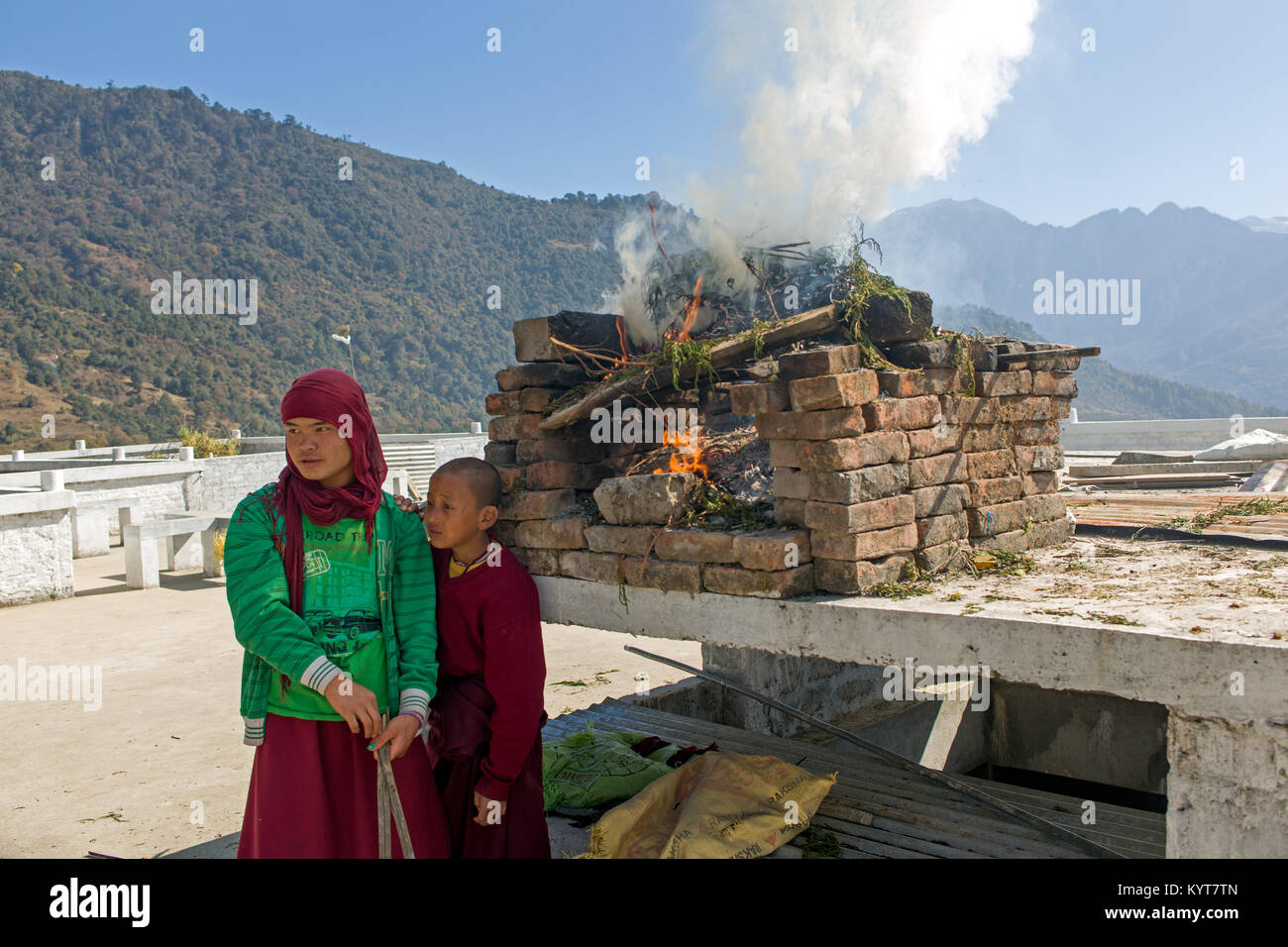 young monks are burning juniper as incense in front of the Khinmey ...