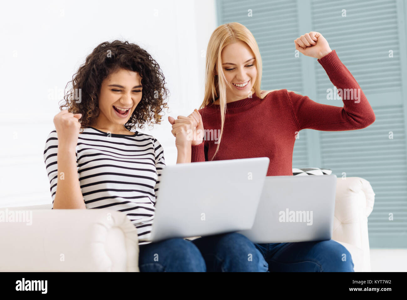 Happy girls raising their arms Stock Photo - Alamy