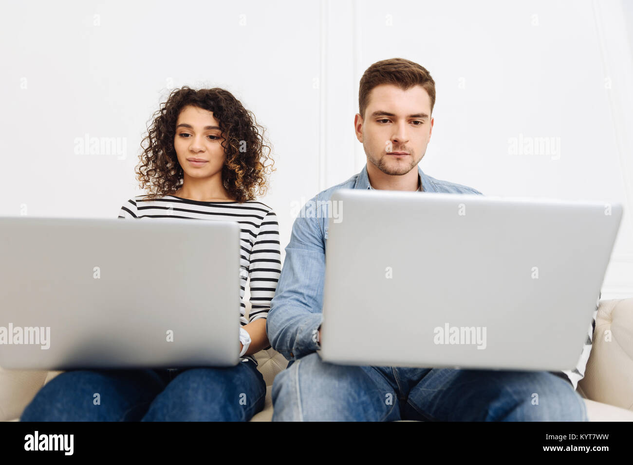 Attentive man looking at screen of his computer Stock Photo - Alamy