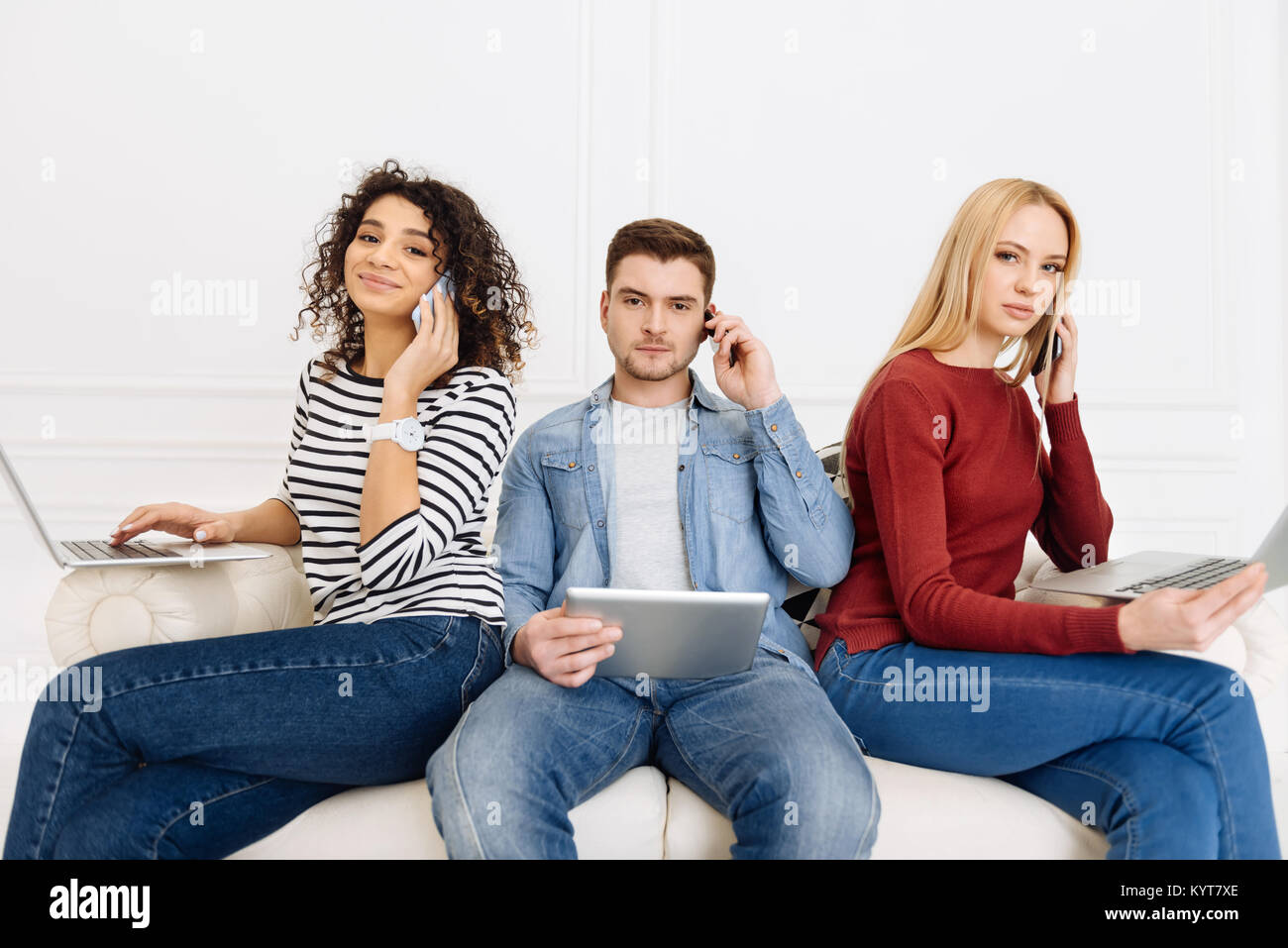 Concentrated blonde female sitting in semi position Stock Photo - Alamy