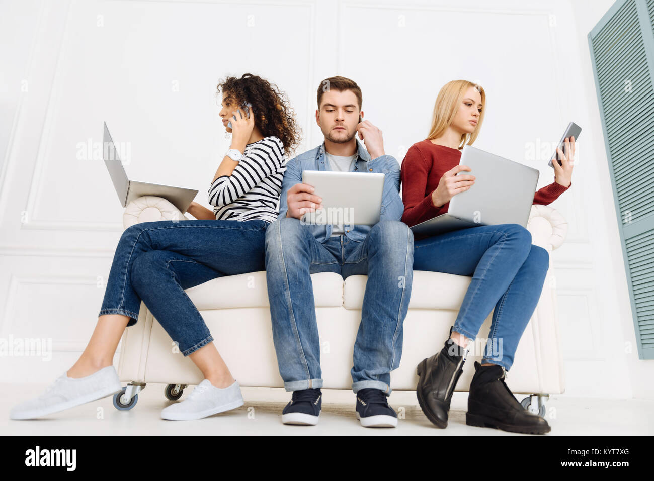 Serious man looking at screen of his tablet Stock Photo - Alamy