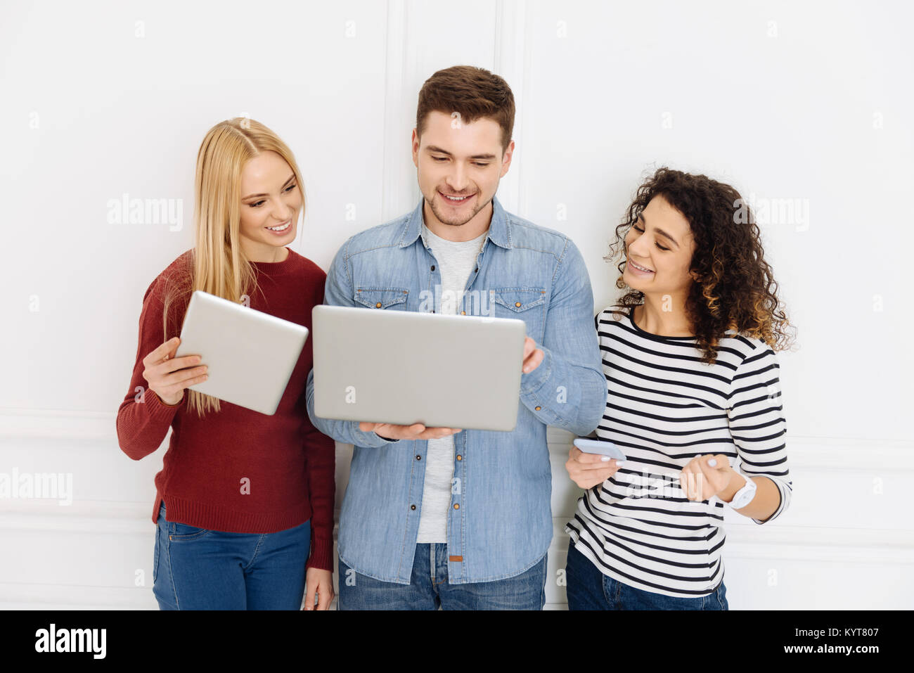 Joyful young man speaking with his friends Stock Photo - Alamy