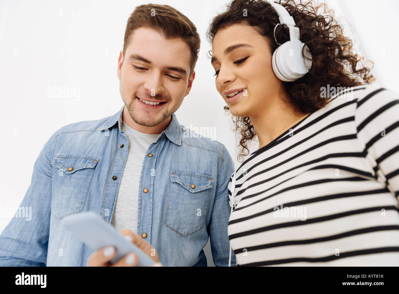 Two friends discussing favorite music Stock Photo - Alamy