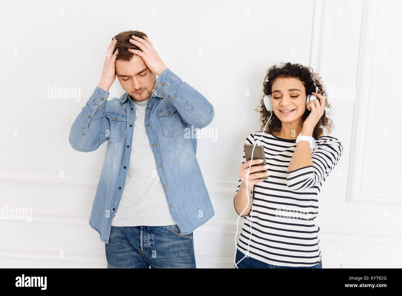Serious male person touching his head Stock Photo - Alamy