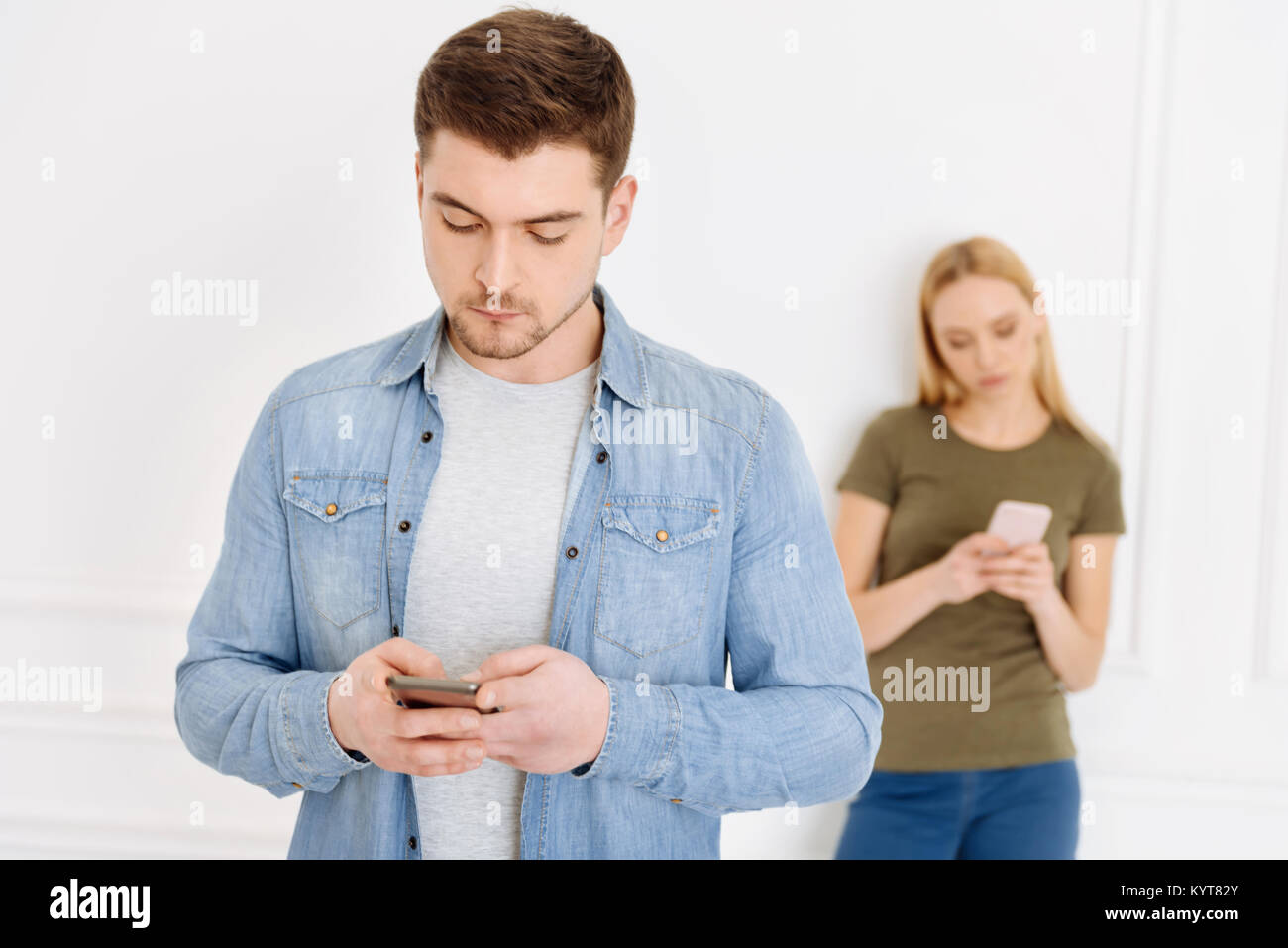 Sad young man chatting with his friends Stock Photo - Alamy