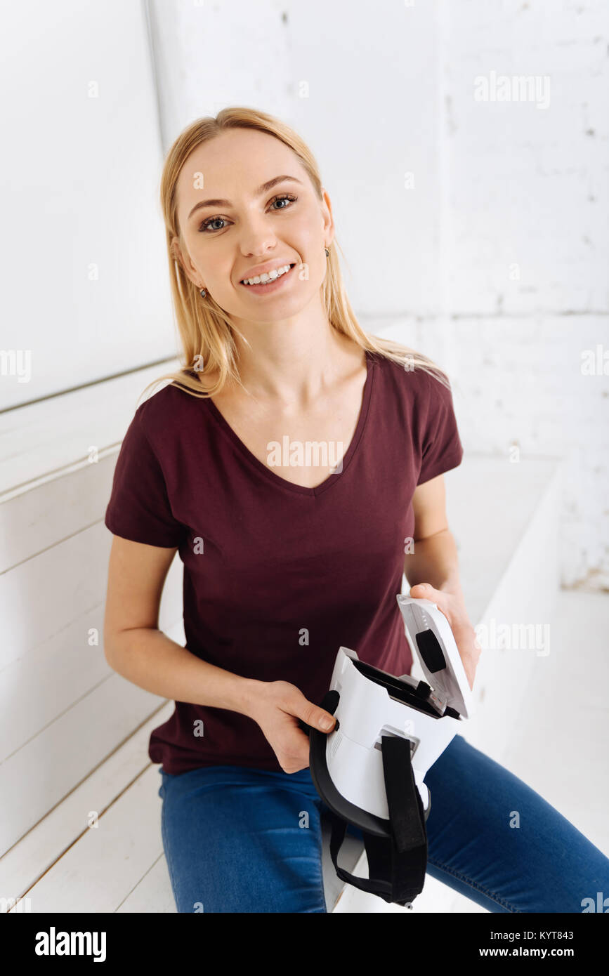Attractive young woman holding mask Stock Photo - Alamy