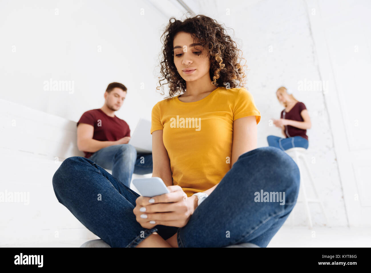 Serious girl chatting with her friends Stock Photo - Alamy