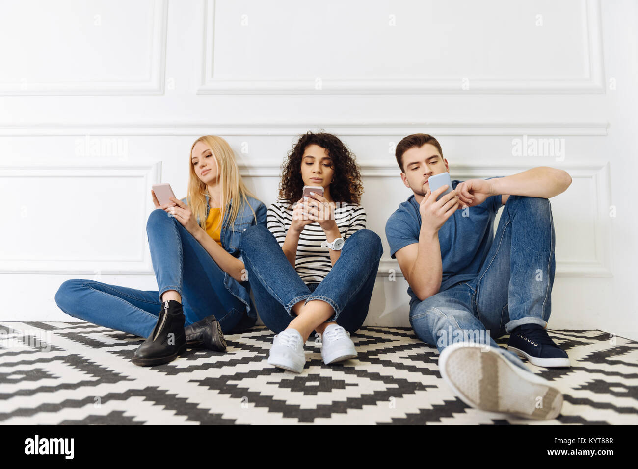 Relaxed students sitting on the floor Stock Photo - Alamy