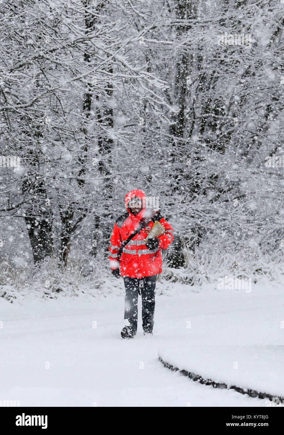 A postman delivers mail in snowy conditions in braco hi-res stock ...