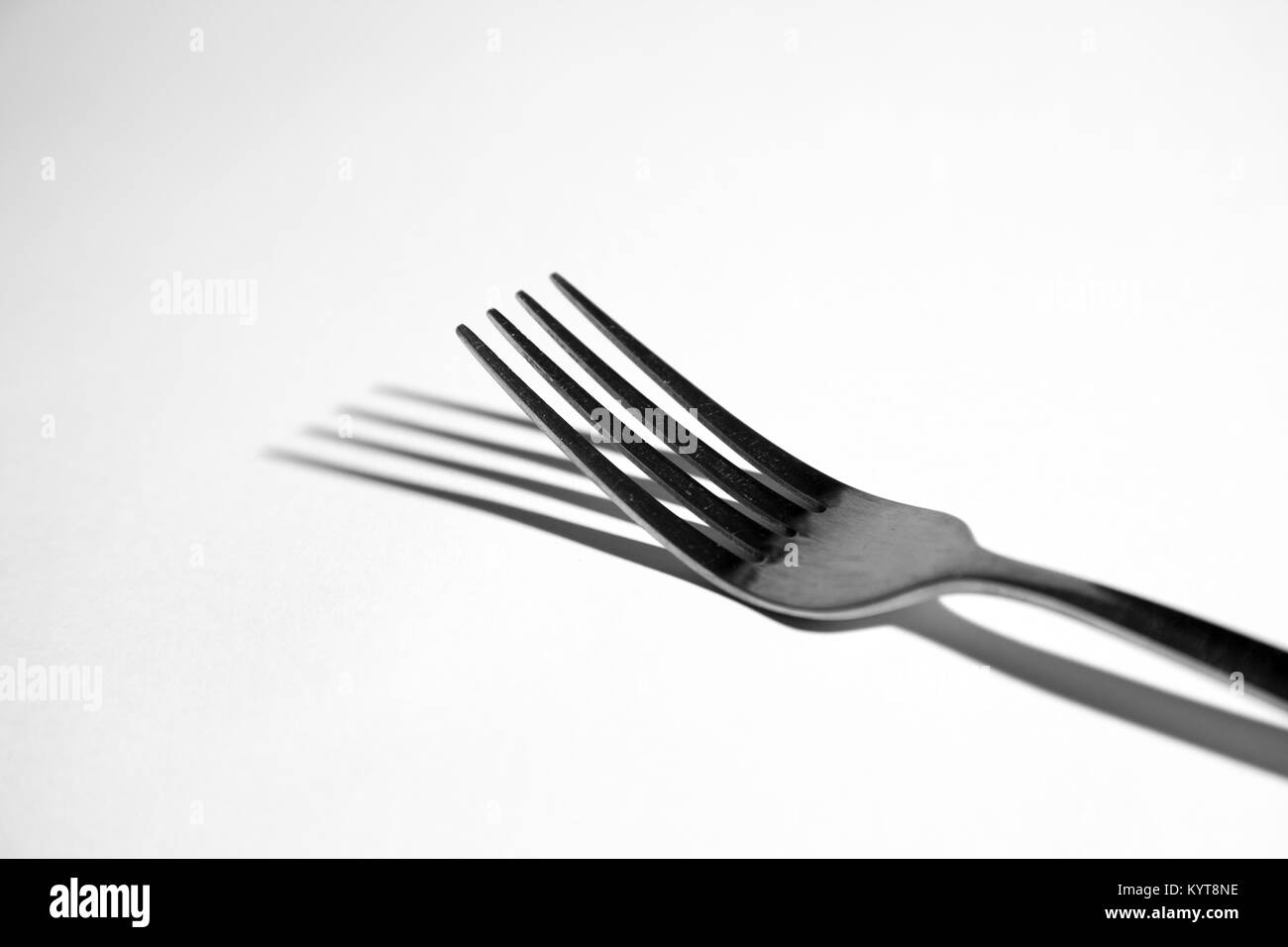 Fork isolated with creative shadow Stock Photo - Alamy