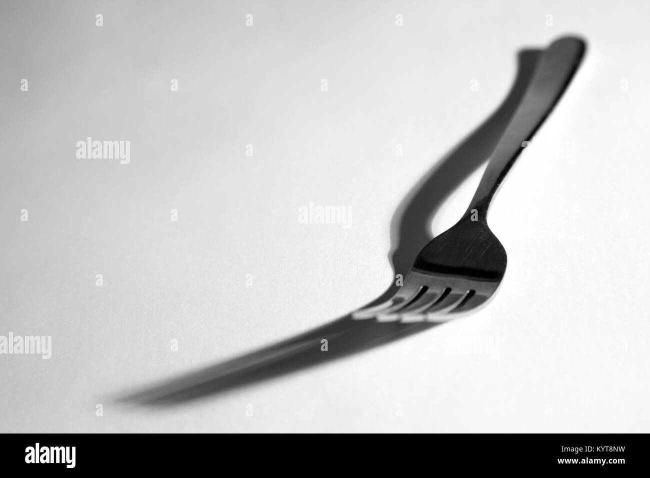 Fork isolated with creative shadow Stock Photo - Alamy