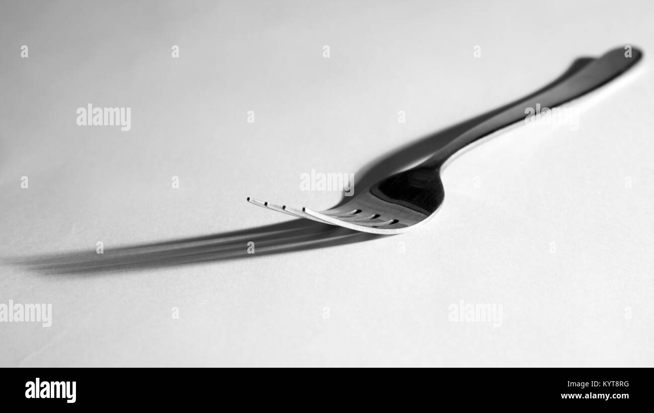 Fork isolated with creative shadow Stock Photo - Alamy
