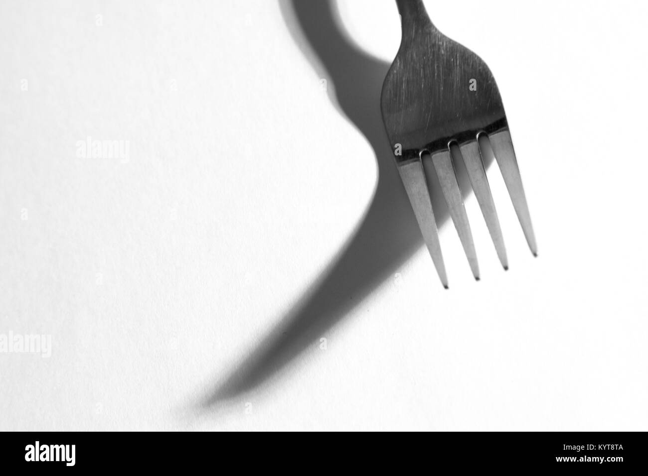 Fork isolated with creative shadow Stock Photo - Alamy