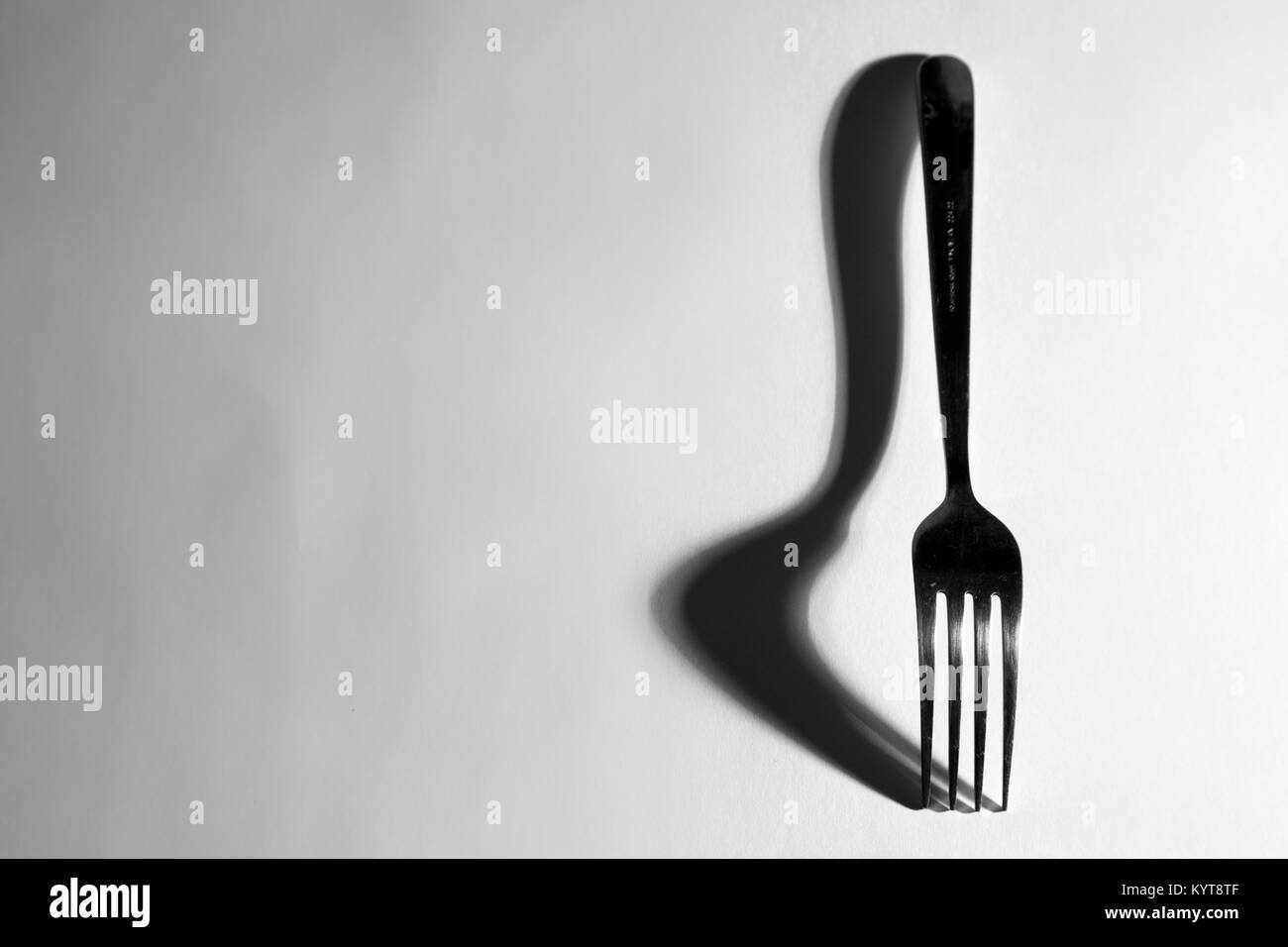 Fork isolated with creative shadow Stock Photo - Alamy