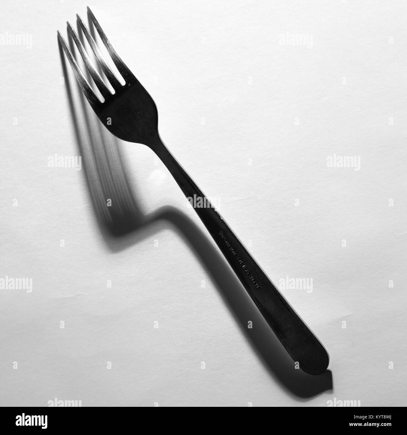 Fork isolated with creative shadow Stock Photo - Alamy