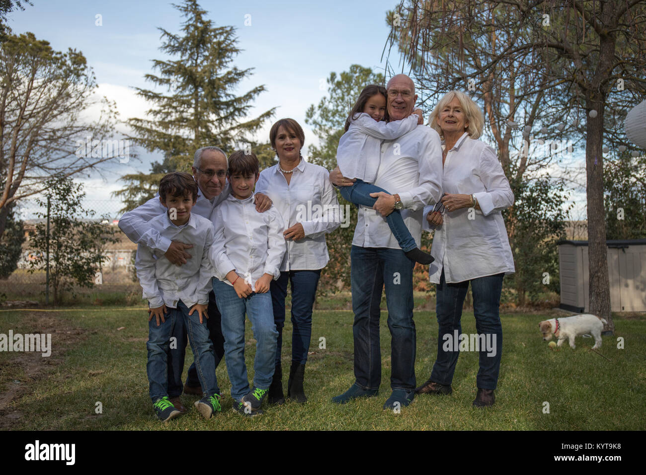 Family of many members, celebrating a party in the garden of their home ...