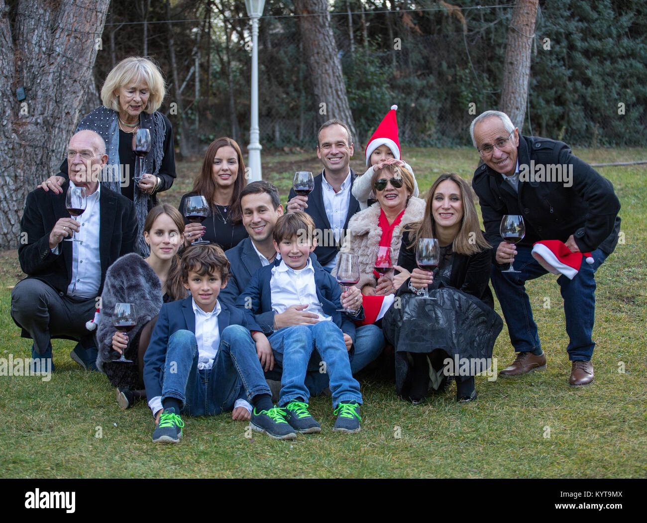 Family of many members, celebrating a party in the garden of their home ...