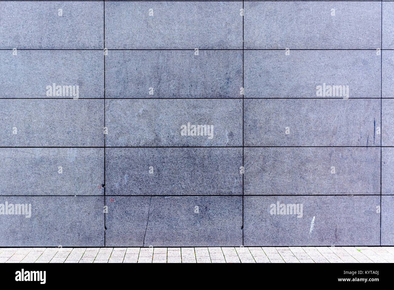 solid grey rock wall and pavement Stock Photo - Alamy