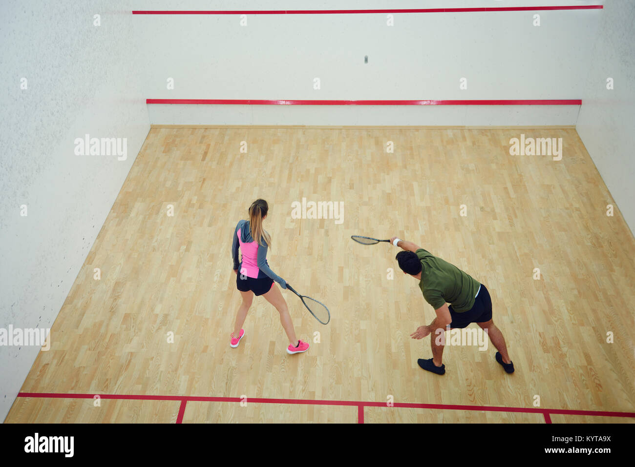 Two friends playing squash together Stock Photo - Alamy