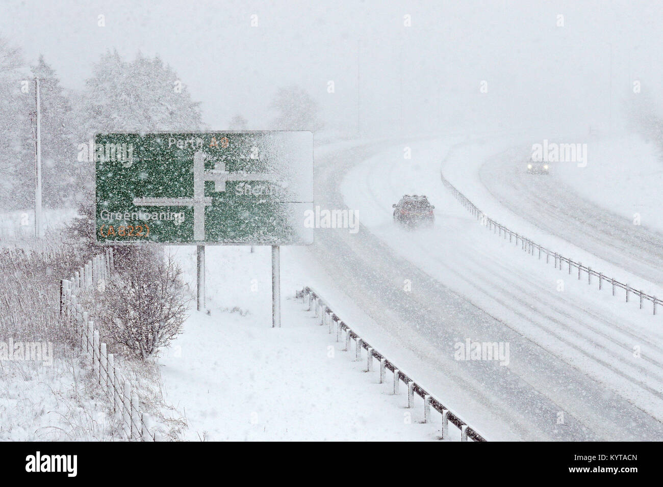 A car traveling in heavy snow on the A9, near the junction for Braco ...