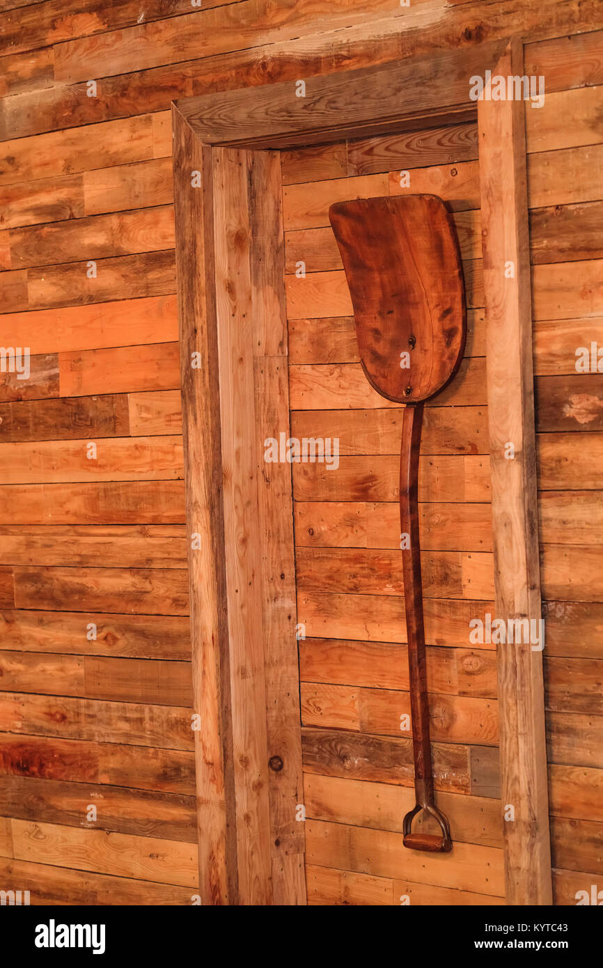 Wood shovel on cottage wooden wall. Decorative shovel made of wood ...