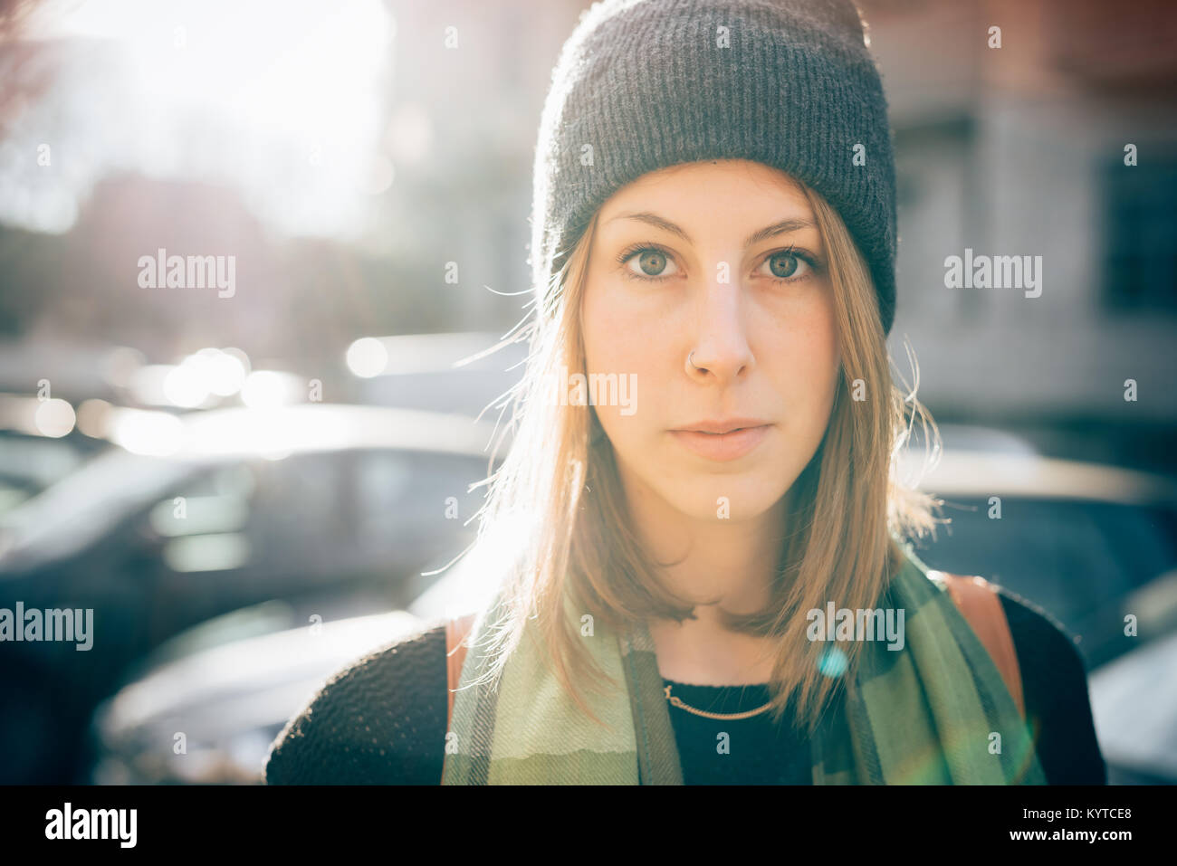 Portrait of young beautiful woman outdoor in the city back light ...