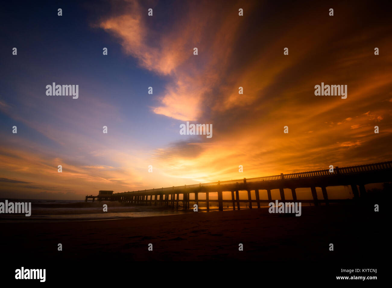 Bridge to sea. Sunset picture of Kerala beach with bridge leading to ...