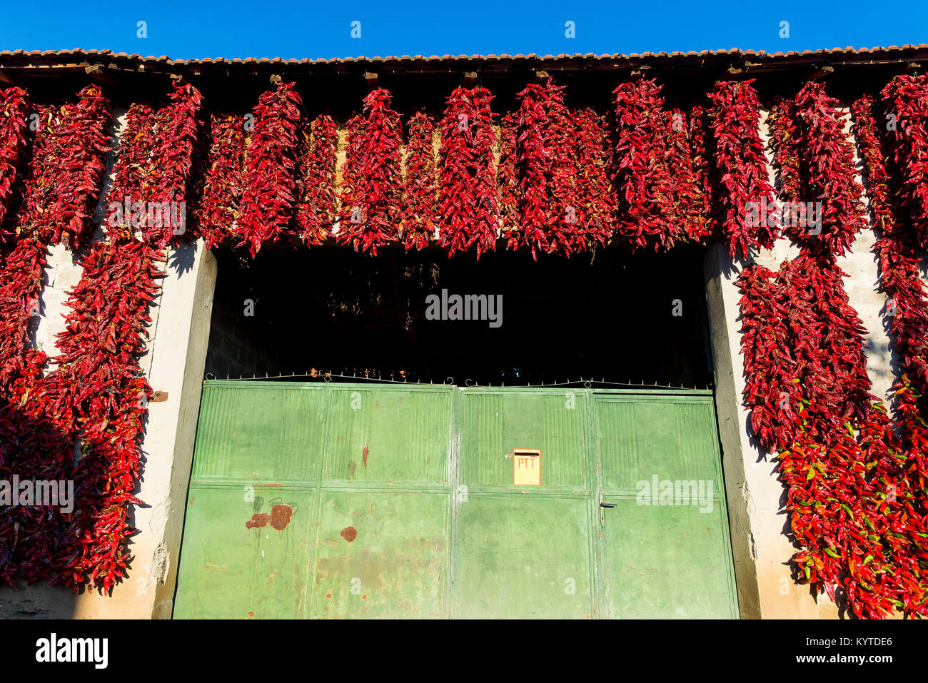 Strings of red peppers dry on house in Serbian village Donja Lokosnica ...