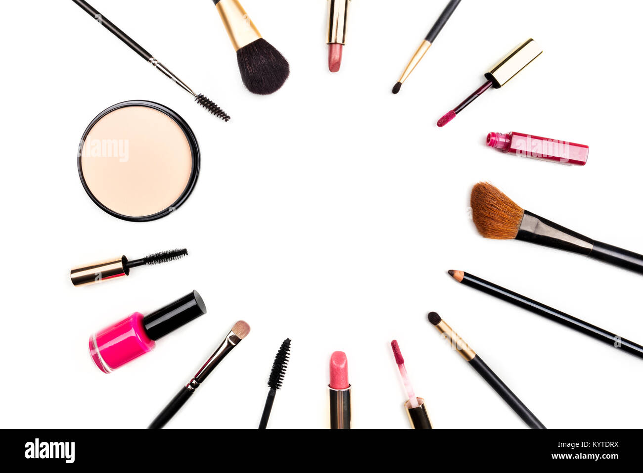 Makeup brushes, pencil, lipstick, and other objects, forming a frame on ...