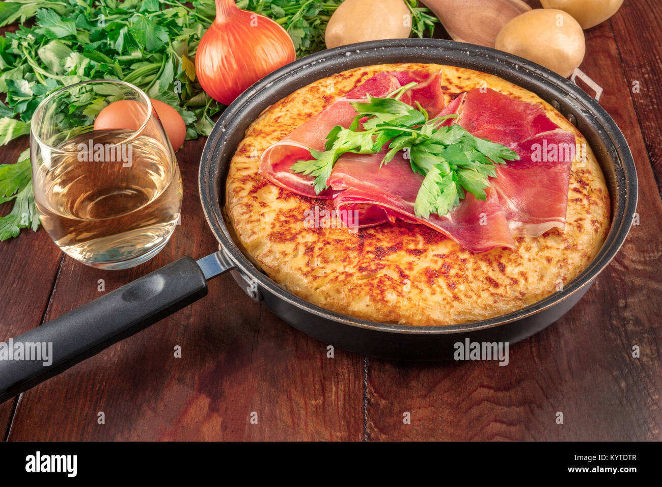 A closeup photo of a Spanish tortilla in a traditional tortillera, with ...