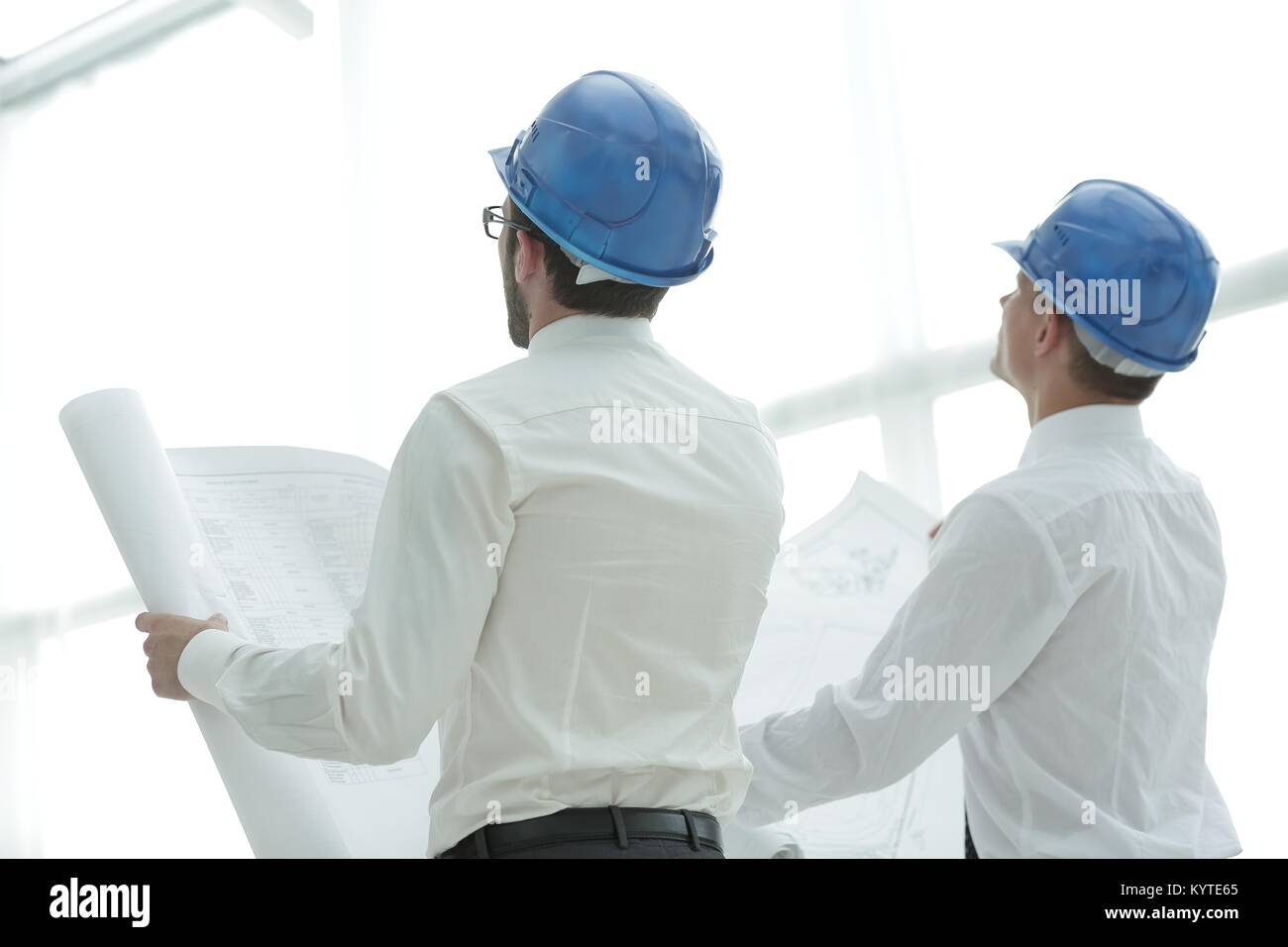 rear view.architect and Builder looking at blank screen Stock Photo - Alamy