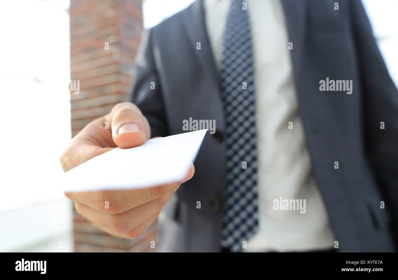Businessman giving a card. Close-up photo in loft office Stock Photo ...