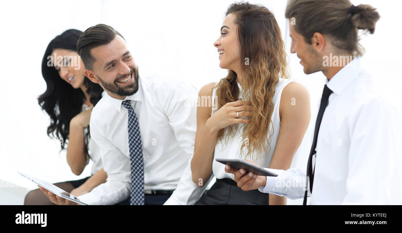 business team with tablet sitting in the office Stock Photo - Alamy