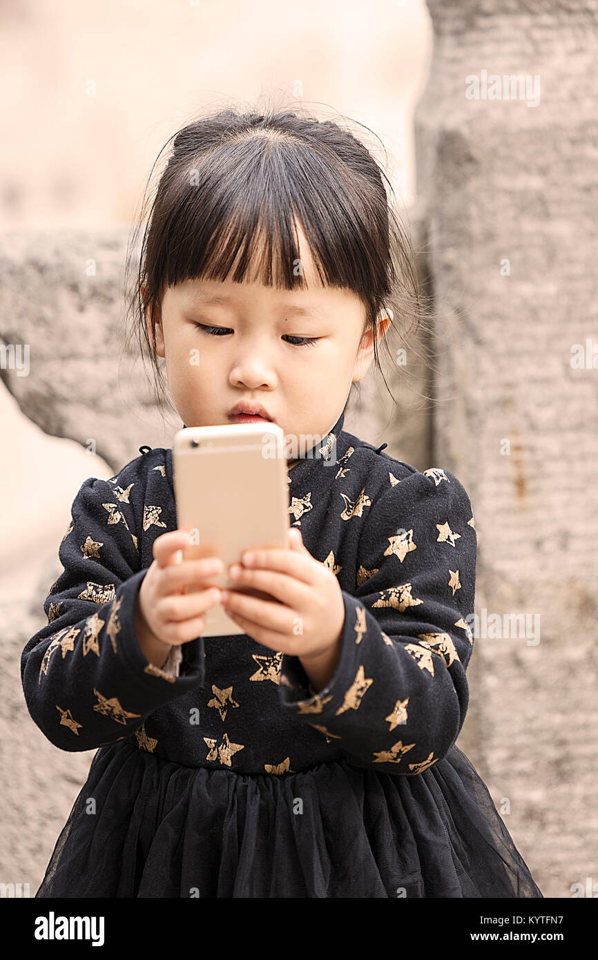 Xian,China - October 22,2017: Little girl plays with the iphone on the ...