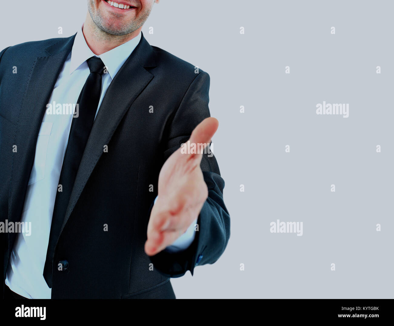 Business man saying welcome and giving hand Stock Photo - Alamy