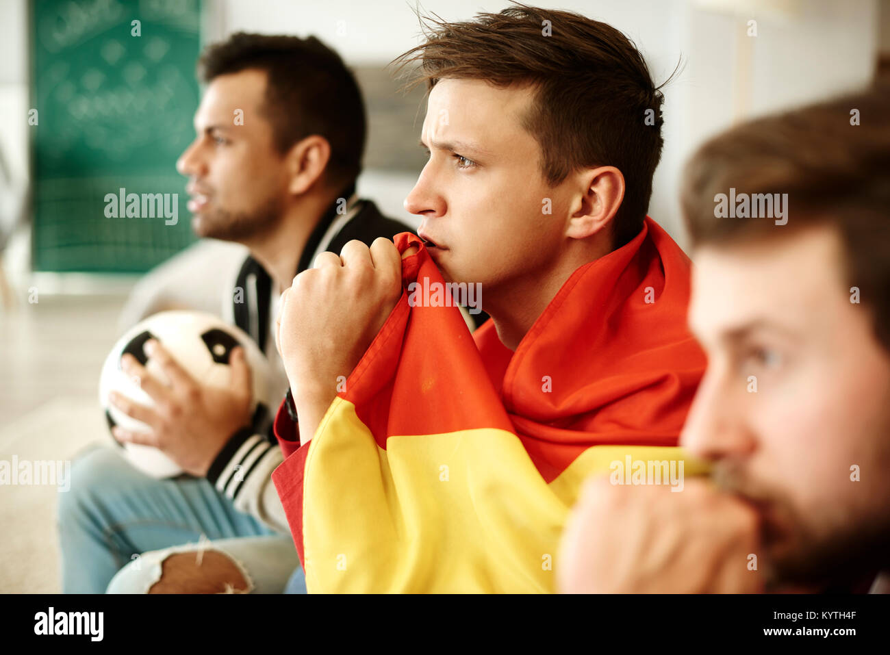Side view of football fans praying at home Stock Photo - Alamy