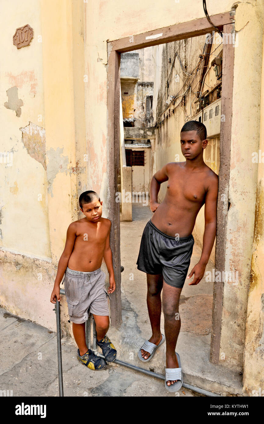 HAVANA, CUBA, OCTOBER 20, 2009. Two young boys posing in a doorway, in ...