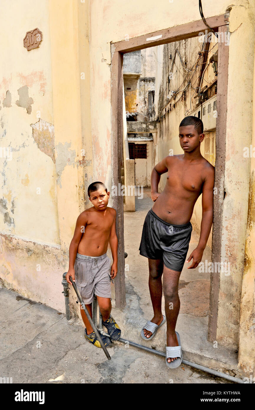 HAVANA, CUBA, OCTOBER 20, 2009. Two young boys posing in a doorway, in ...
