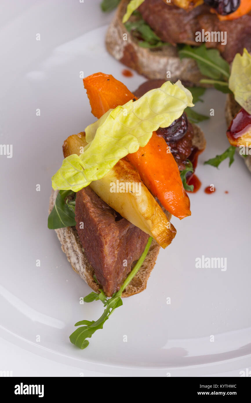 Roasted beef chick on a toast served with sauted carrot Stock Photo - Alamy
