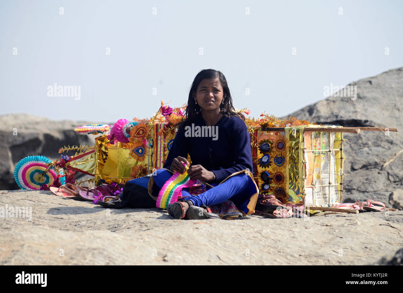 Purulia, India. 16th Jan, 2018. Tribal girl sits with Tusu idol beside ...