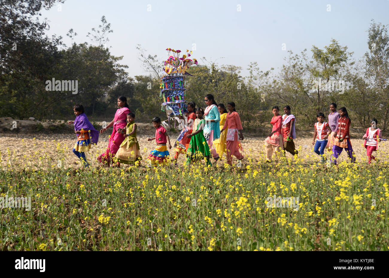 Purulia, India. 16th Jan, 2018. Tribal women carry Tusu idols through ...