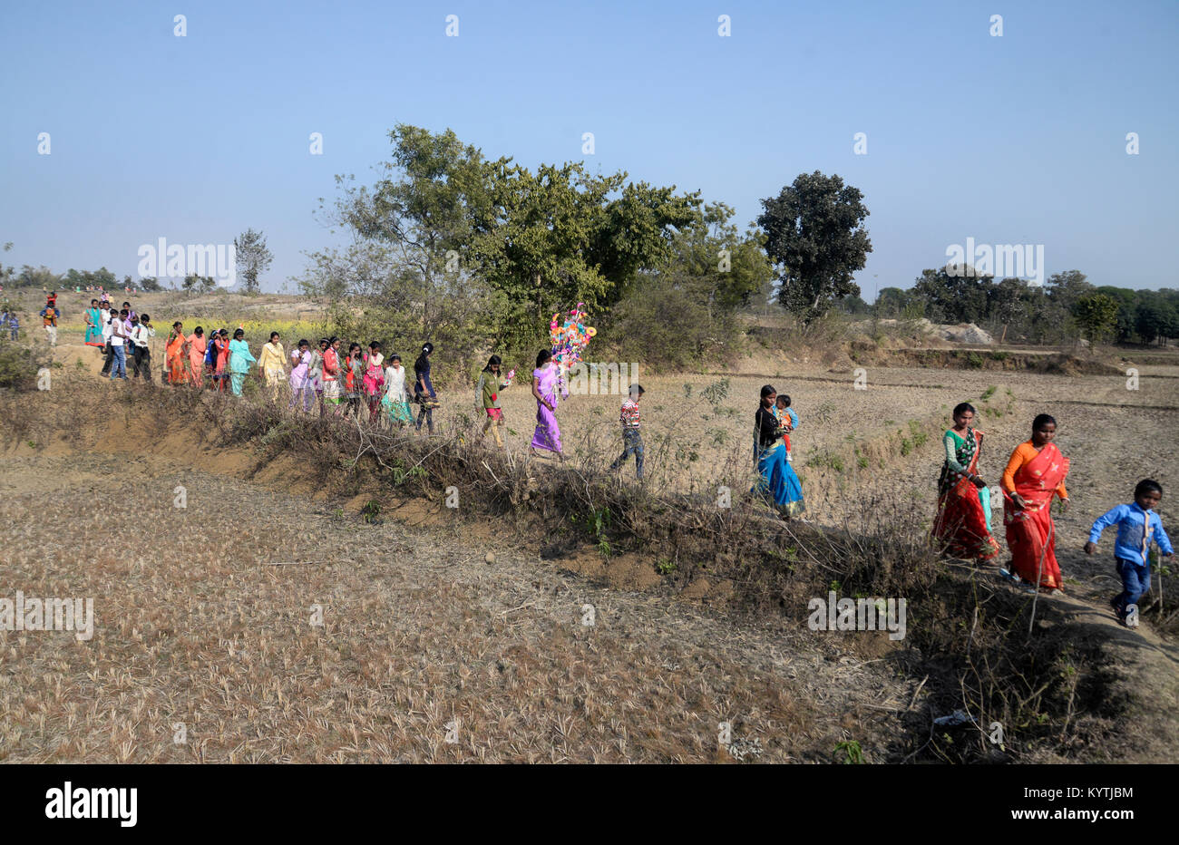 Purulia, India. 16th Jan, 2018. Tribal women carry Tusu idols through ...