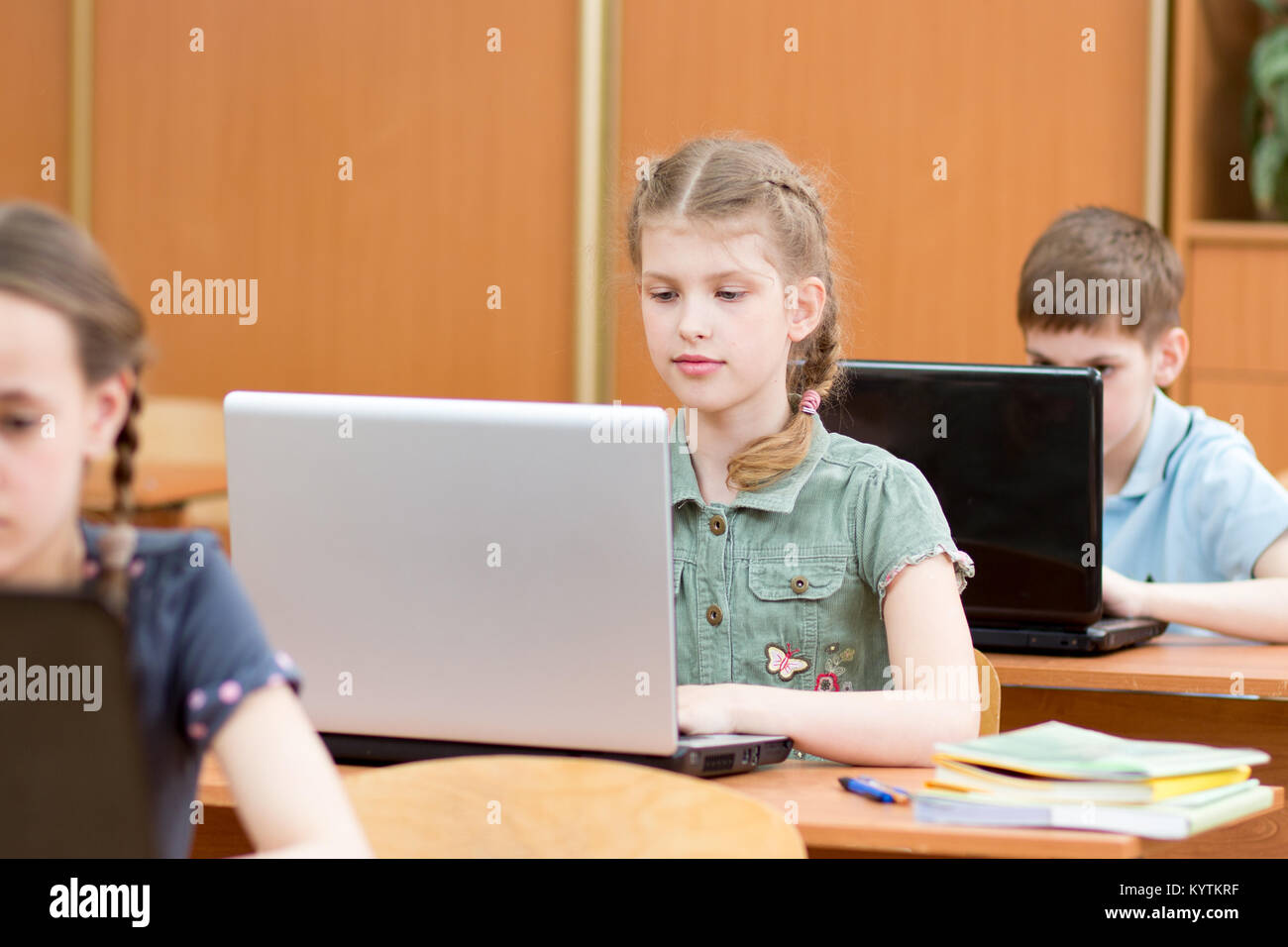 school children using laptop at lesson in classroom Stock Photo - Alamy